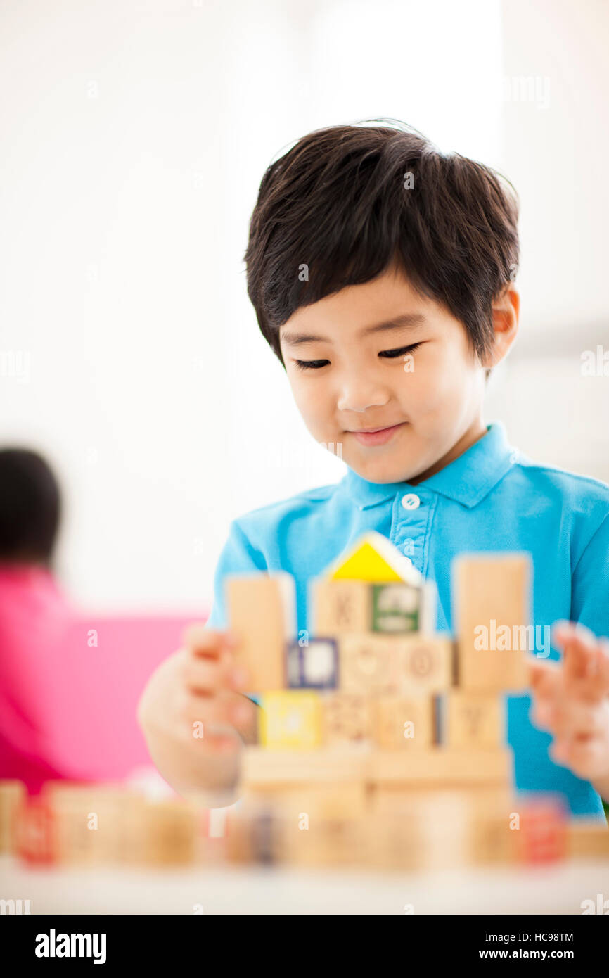 Portrait of smiling boy playing with blocks Stock Photo - Alamy