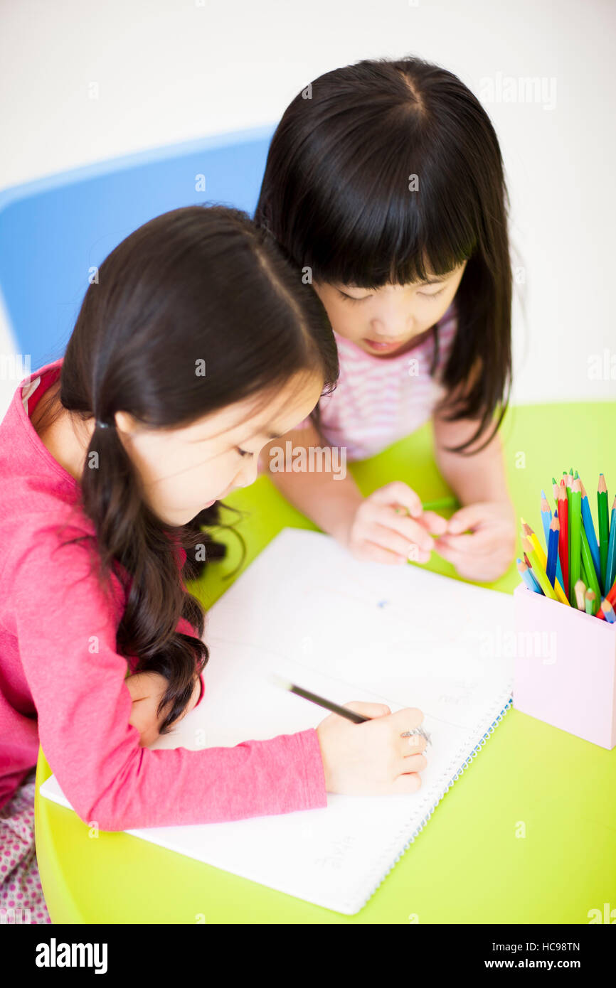Portrait of two girls drawing Stock Photo - Alamy