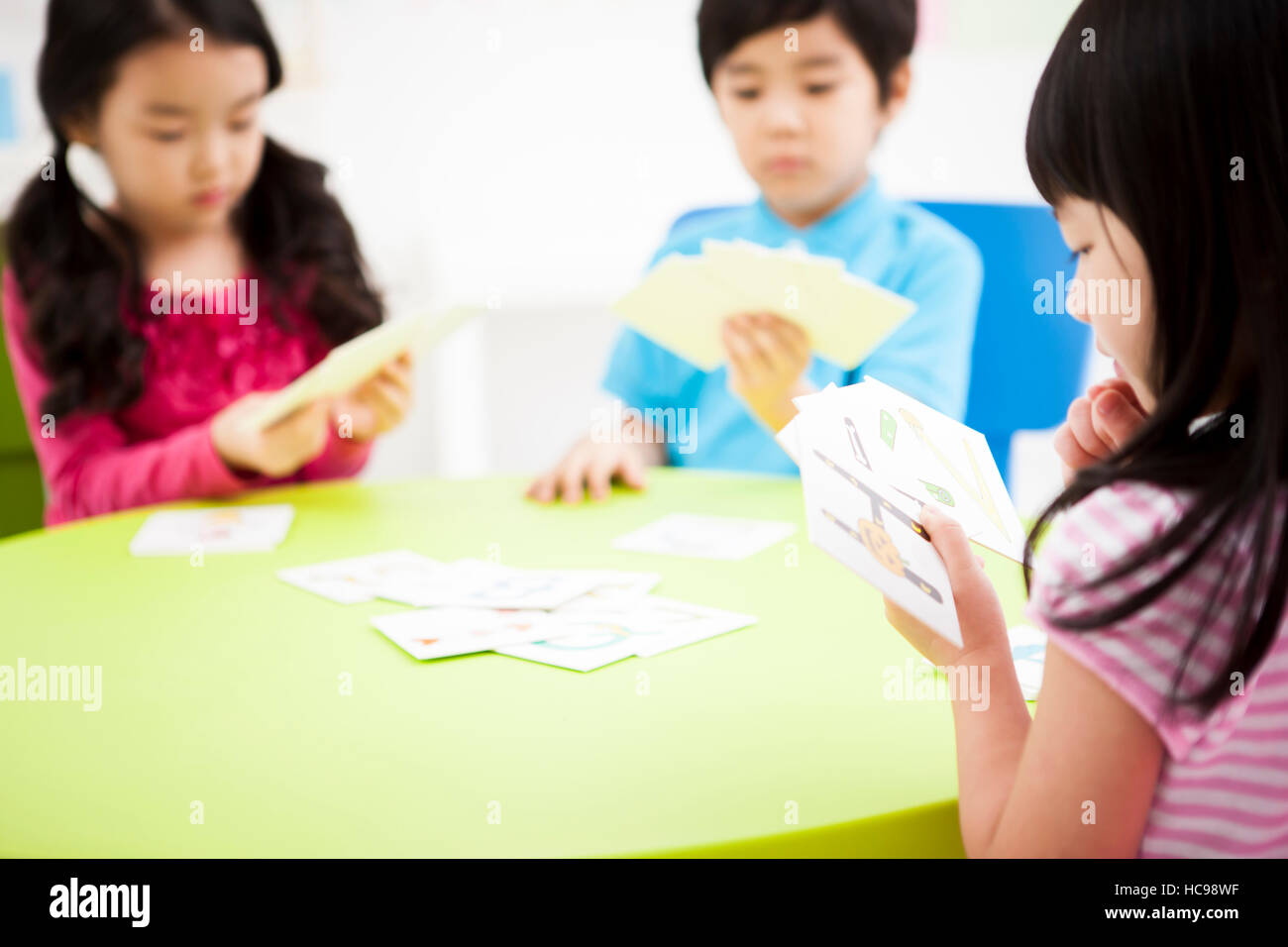 Portrait of children playing cards Stock Photo - Alamy