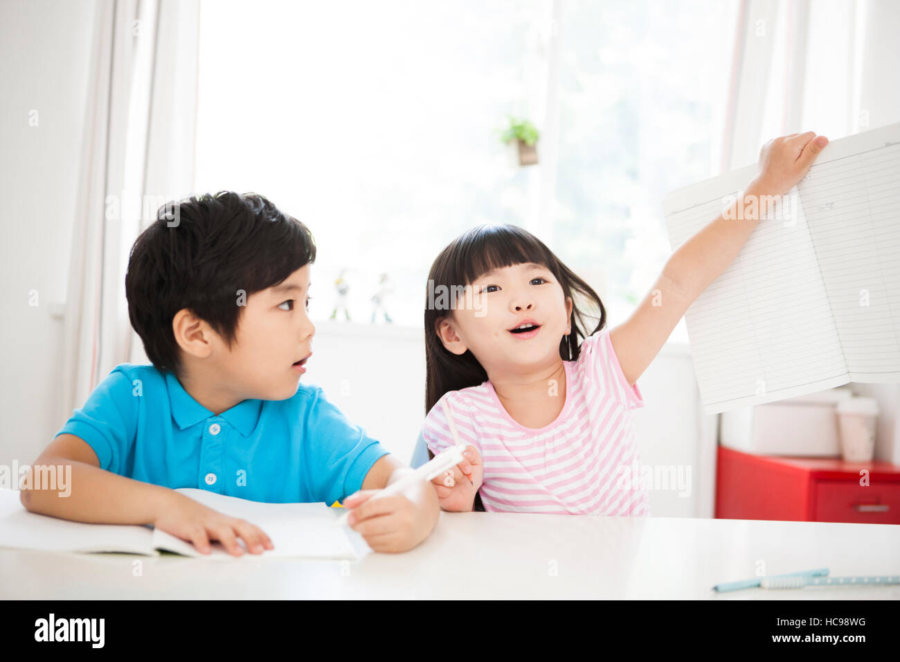 Portrait of smiling boy and girl studying Stock Photo - Alamy