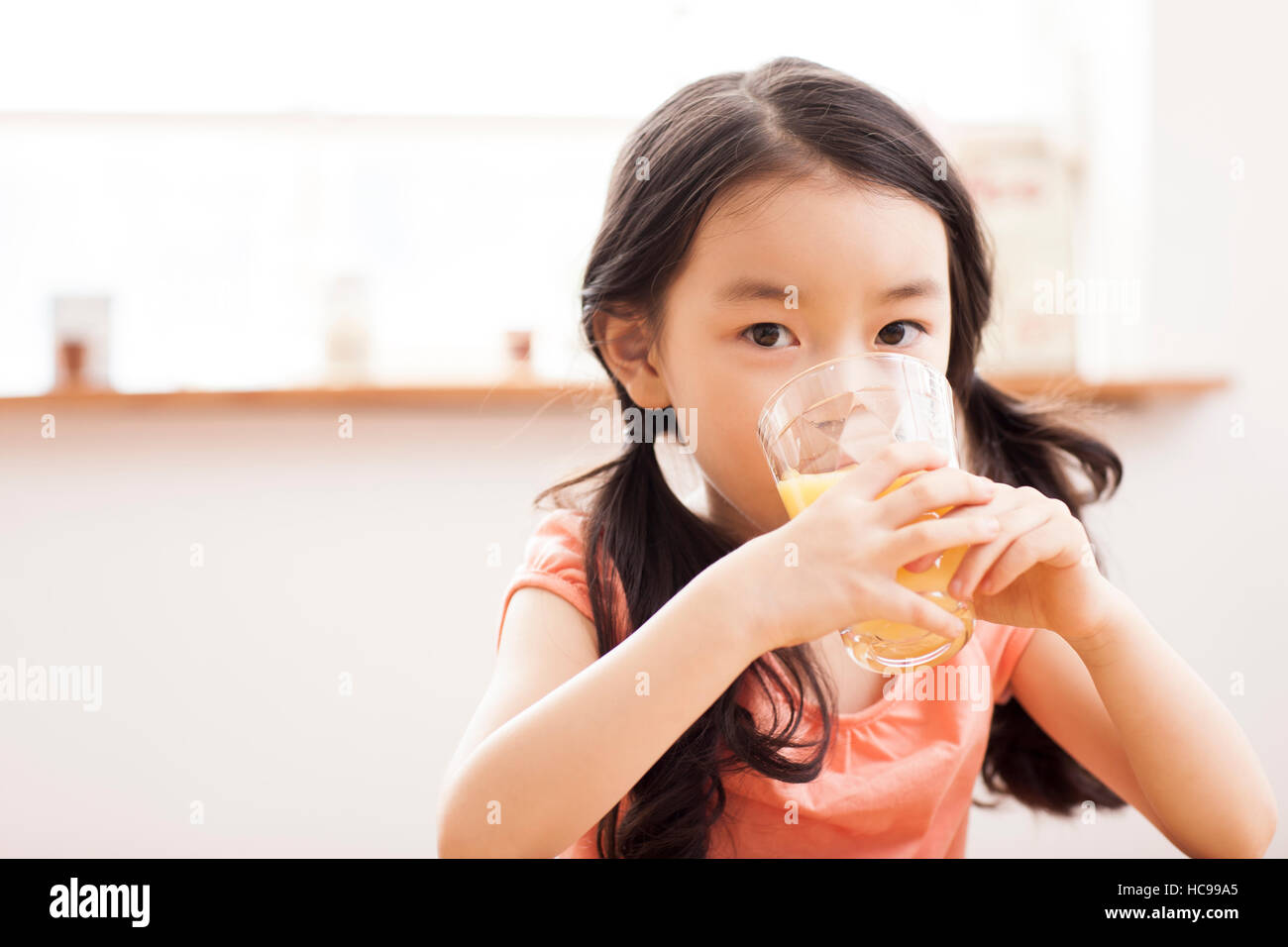 Portrait of girl drinking juice Stock Photo - Alamy