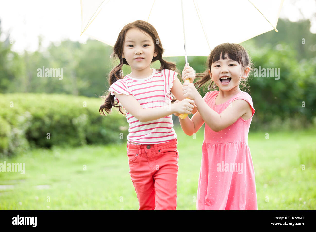 People Sharing An Umbrella
