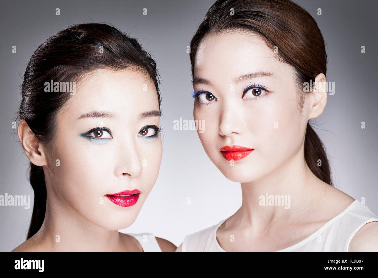 Portrait of two young Korean women with red lips Stock Photo - Alamy