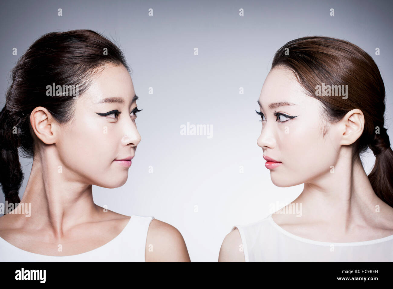 Side view portrait of two young Korean women with ponytails Stock Photo ...
