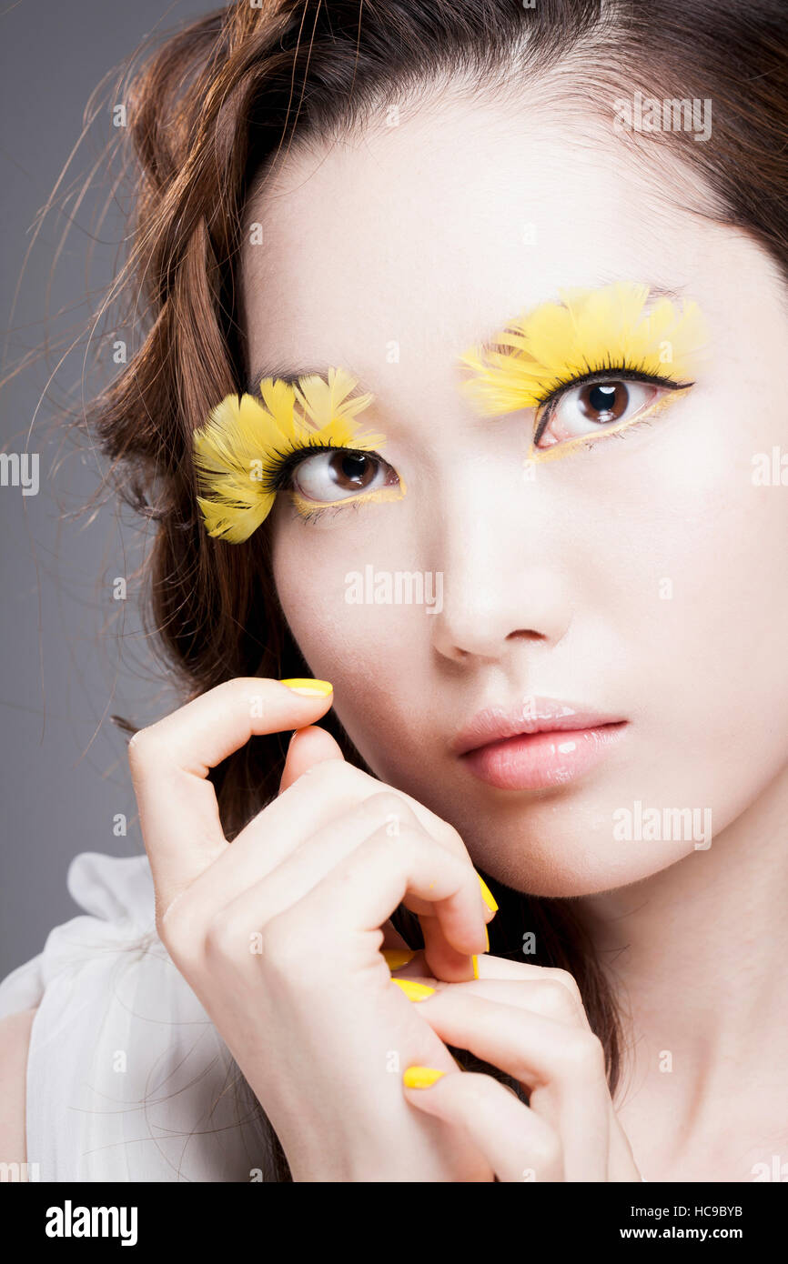 Portrait of young Korean woman with yellow fake eyelashes Stock Photo ...
