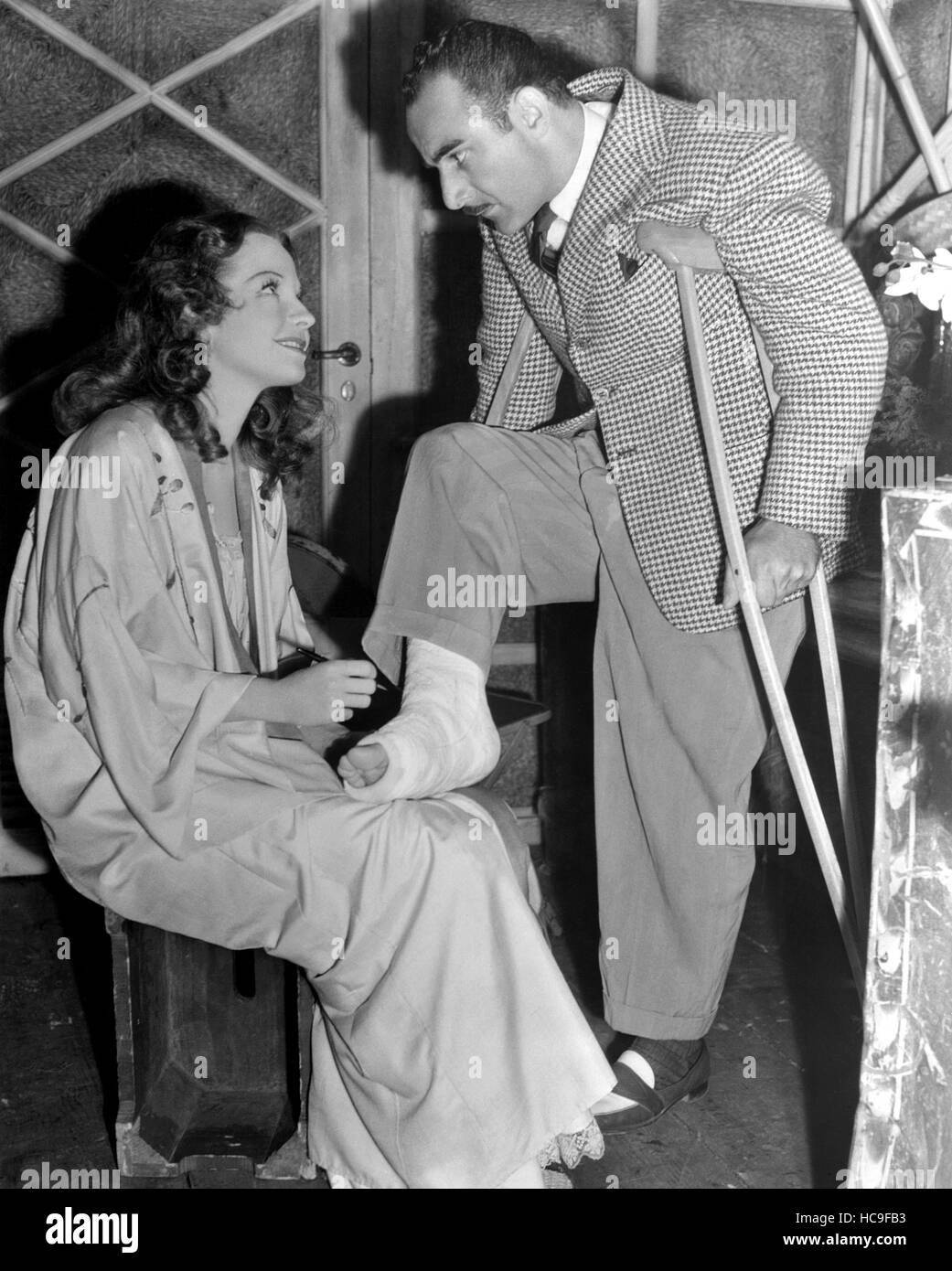 VICTORY, from left: Betty Field signing Fritz Feld's cast, on-set, 1940 ...