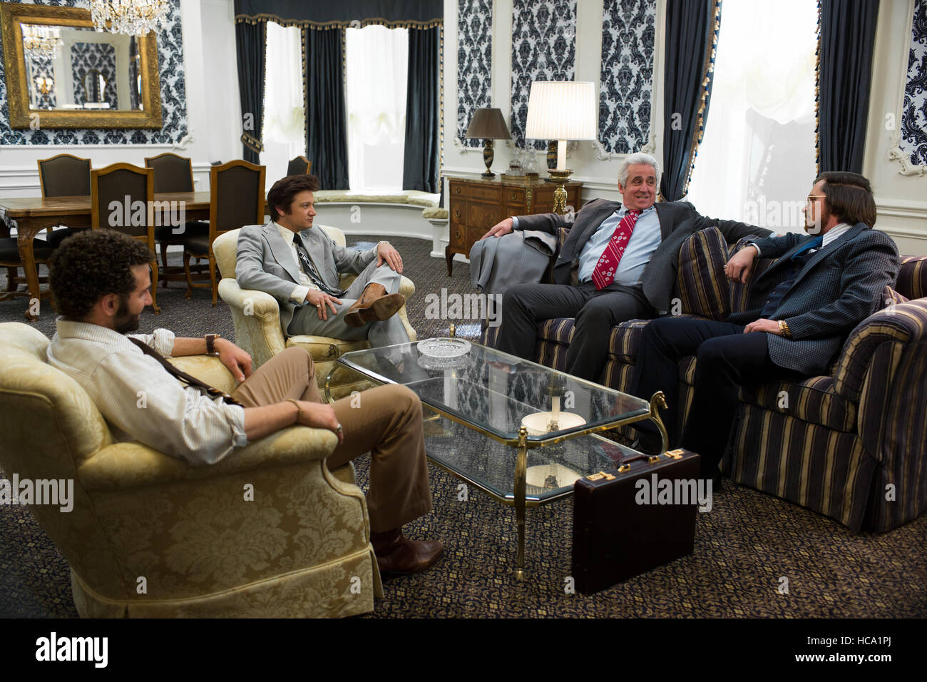 AMERICAN HUSTLE, from left: Bradley Cooper, Jeremy Renner, Charley ...