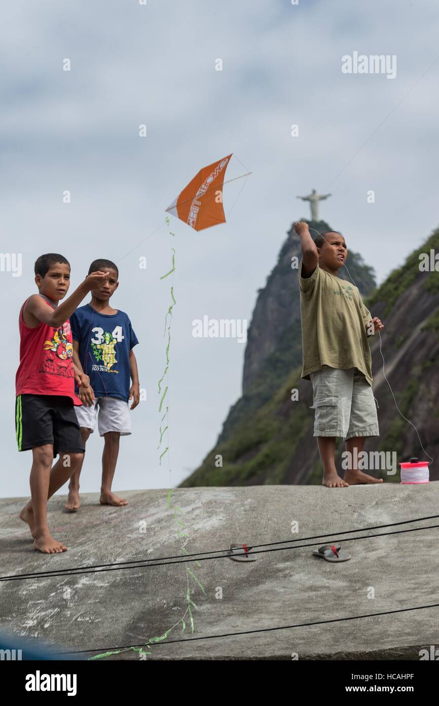Young Brazilian boys fly a kite in the Favela Santa Marta with the ...