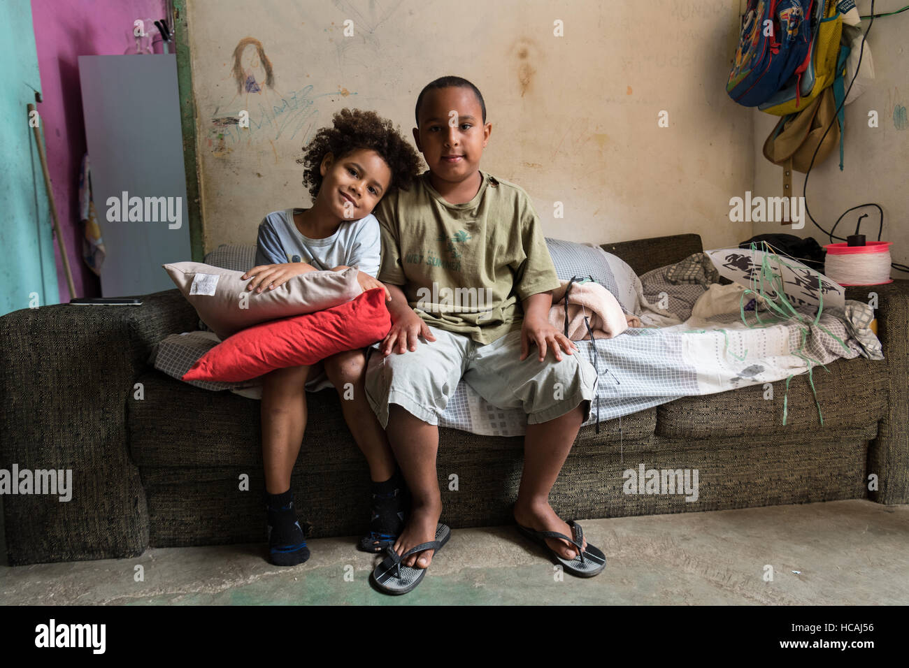 Two children poses for a photo inside a home in the Favela Santa Marta ...