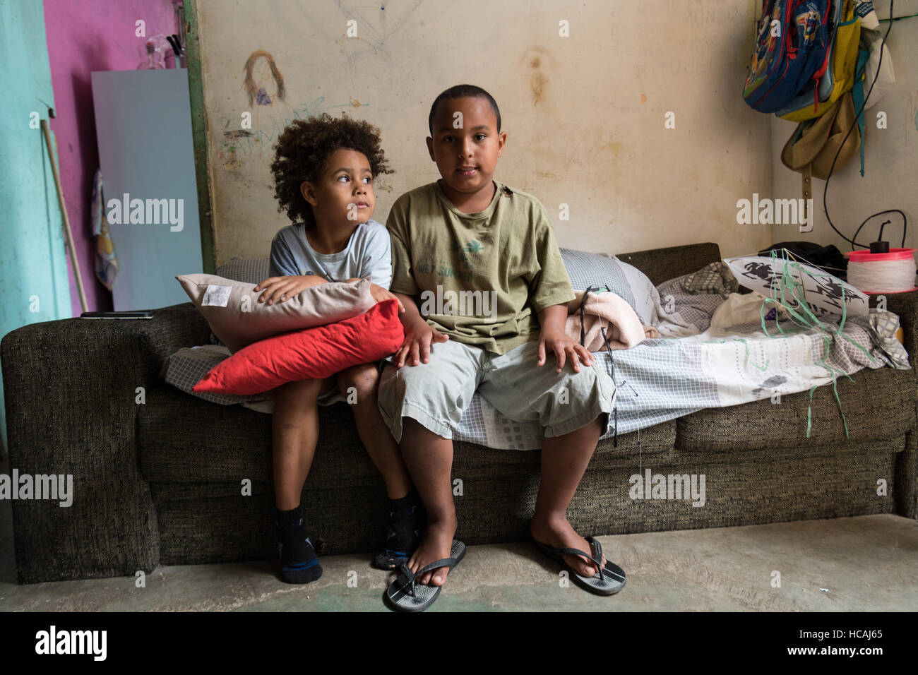 Two children poses for a photo inside a home in the Favela Santa Marta ...