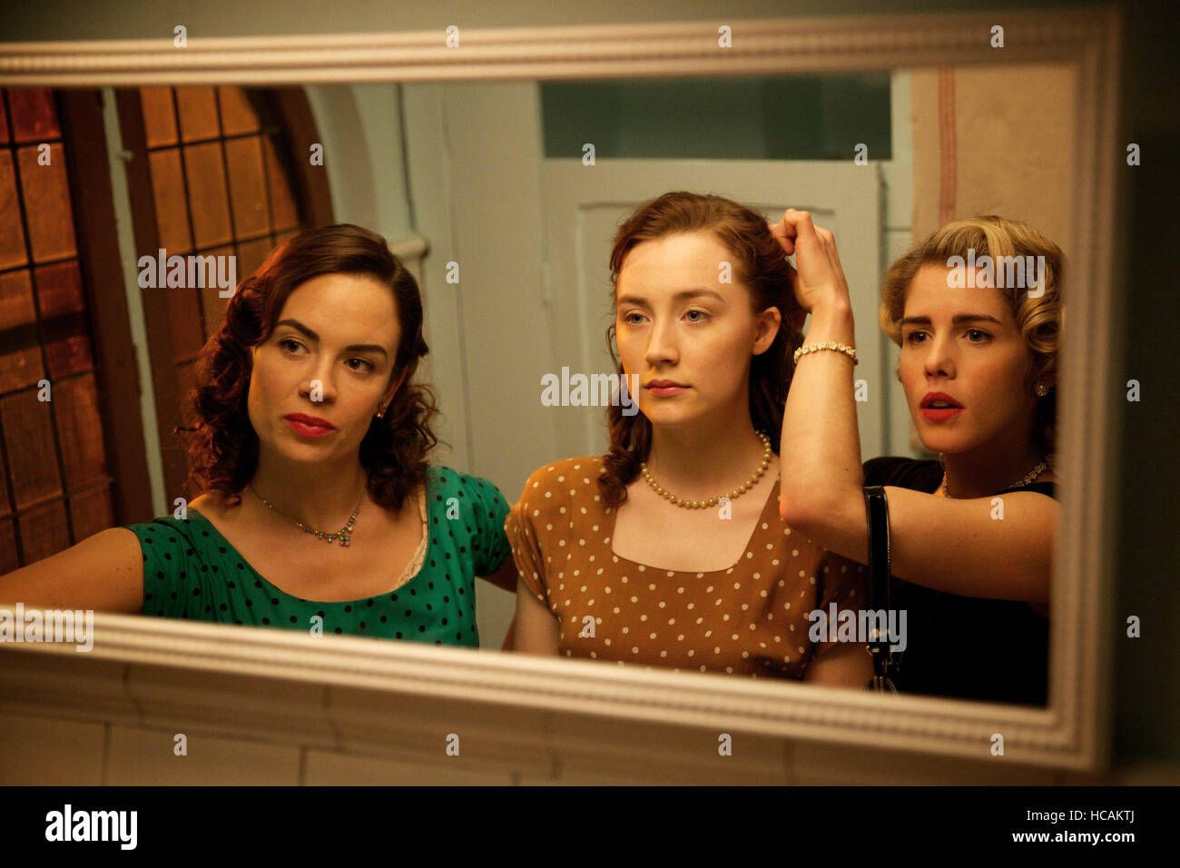 BROOKLYN, from left: Eve Macklin, Saoirse Ronan, Emily Bett Rickards, 2015. ph: Kerry Brown/TM ...