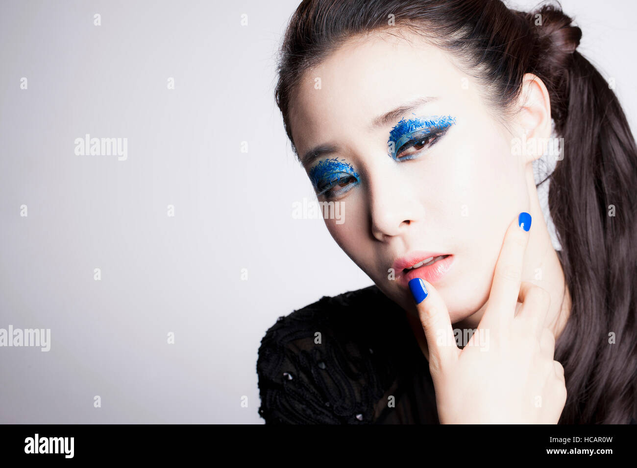 Portrait of young Korean woman in blue eye shadow Stock Photo - Alamy