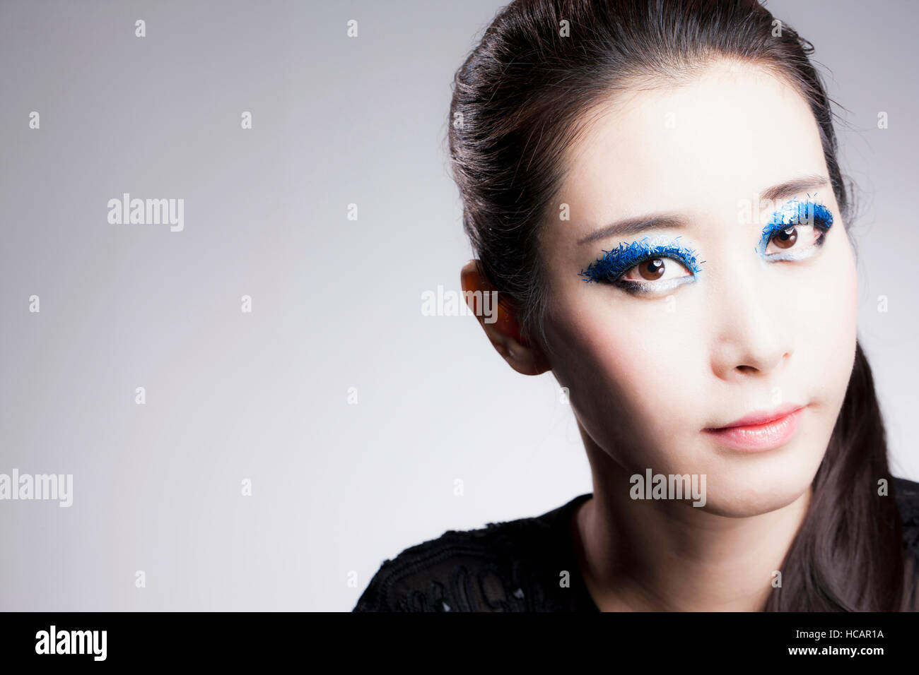 Portrait of young Korean woman in blue eye shadow Stock Photo - Alamy