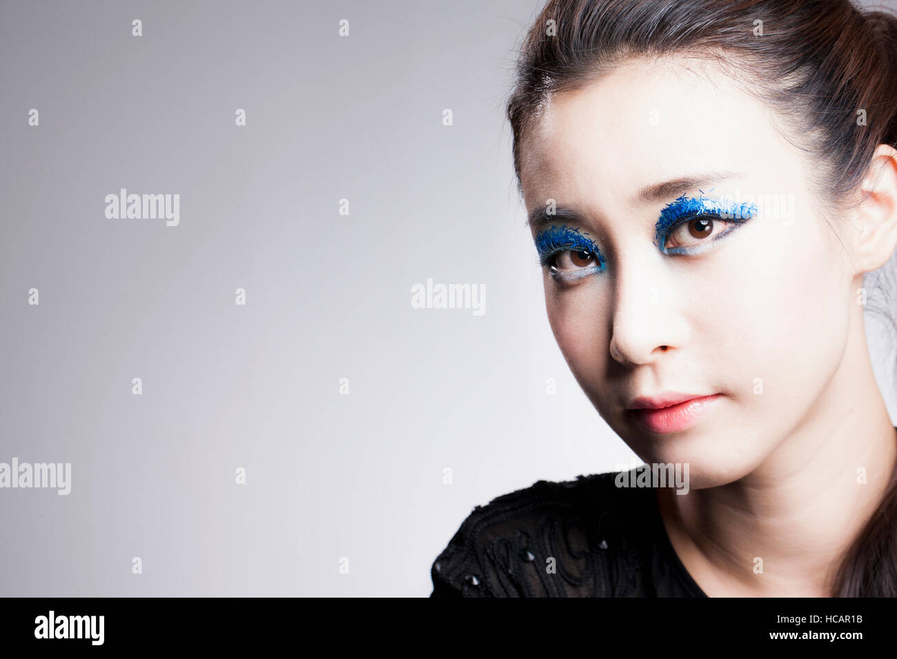 Portrait of young Korean woman in blue eye shadow Stock Photo - Alamy