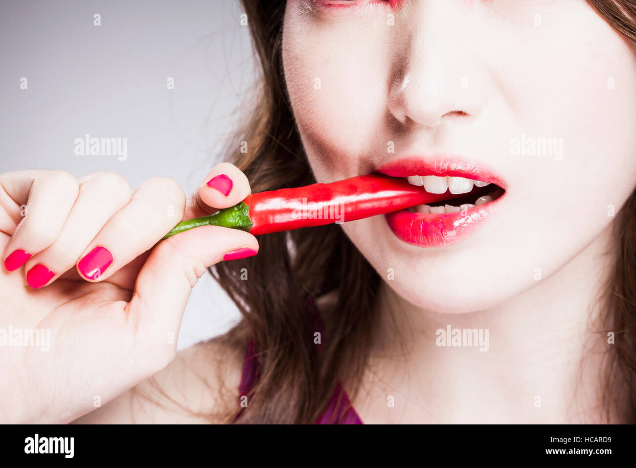 Portrait of young Korean woman eating red pepper Stock Photo - Alamy