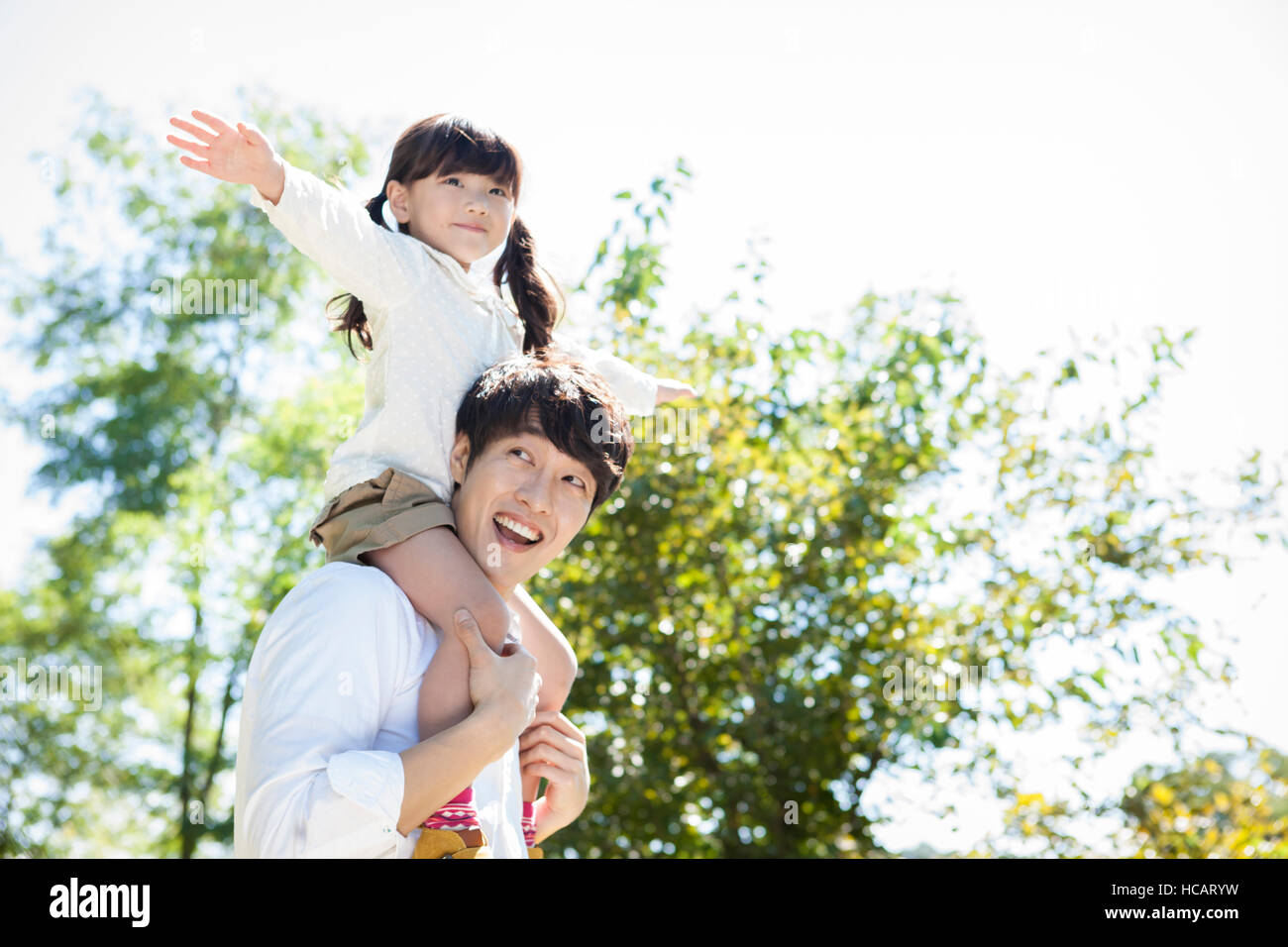 Loving father carrying his daughter on his shoulders Stock Photo - Alamy