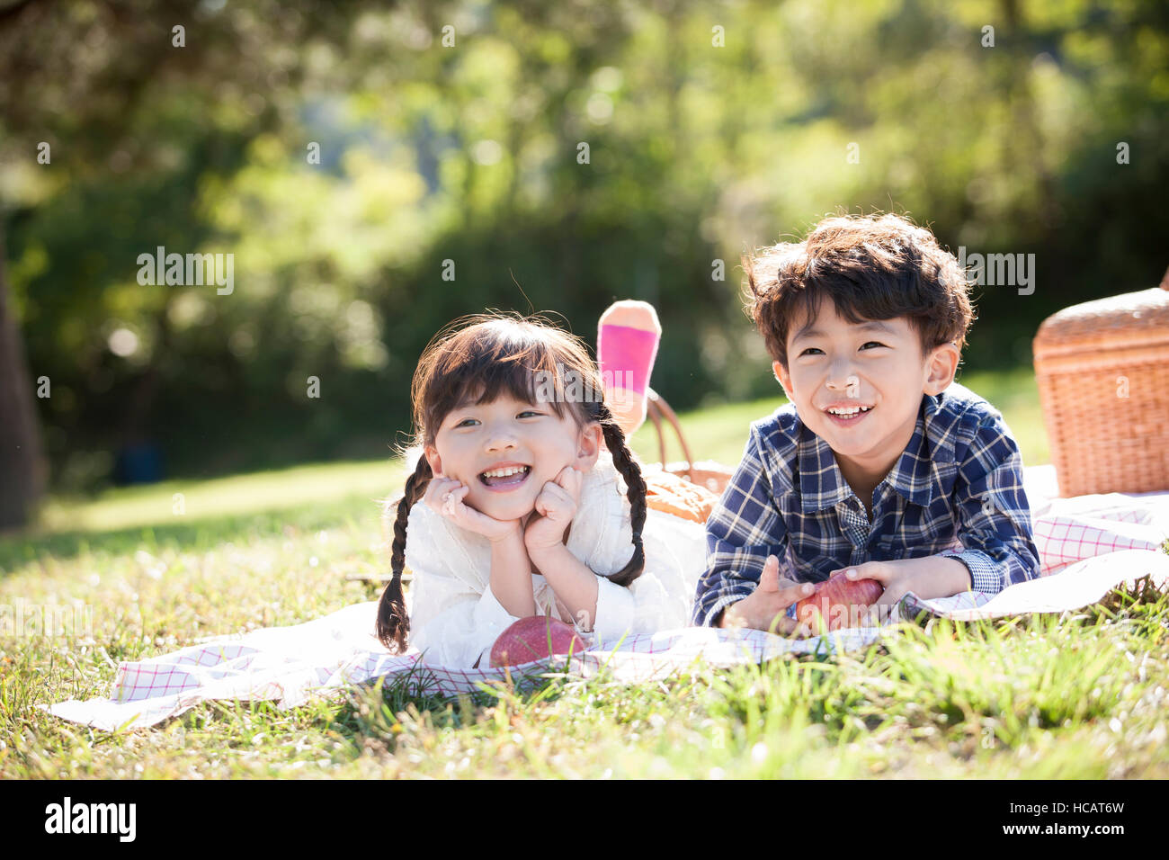 Smiling boy and girl having a picnic Stock Photo - Alamy
