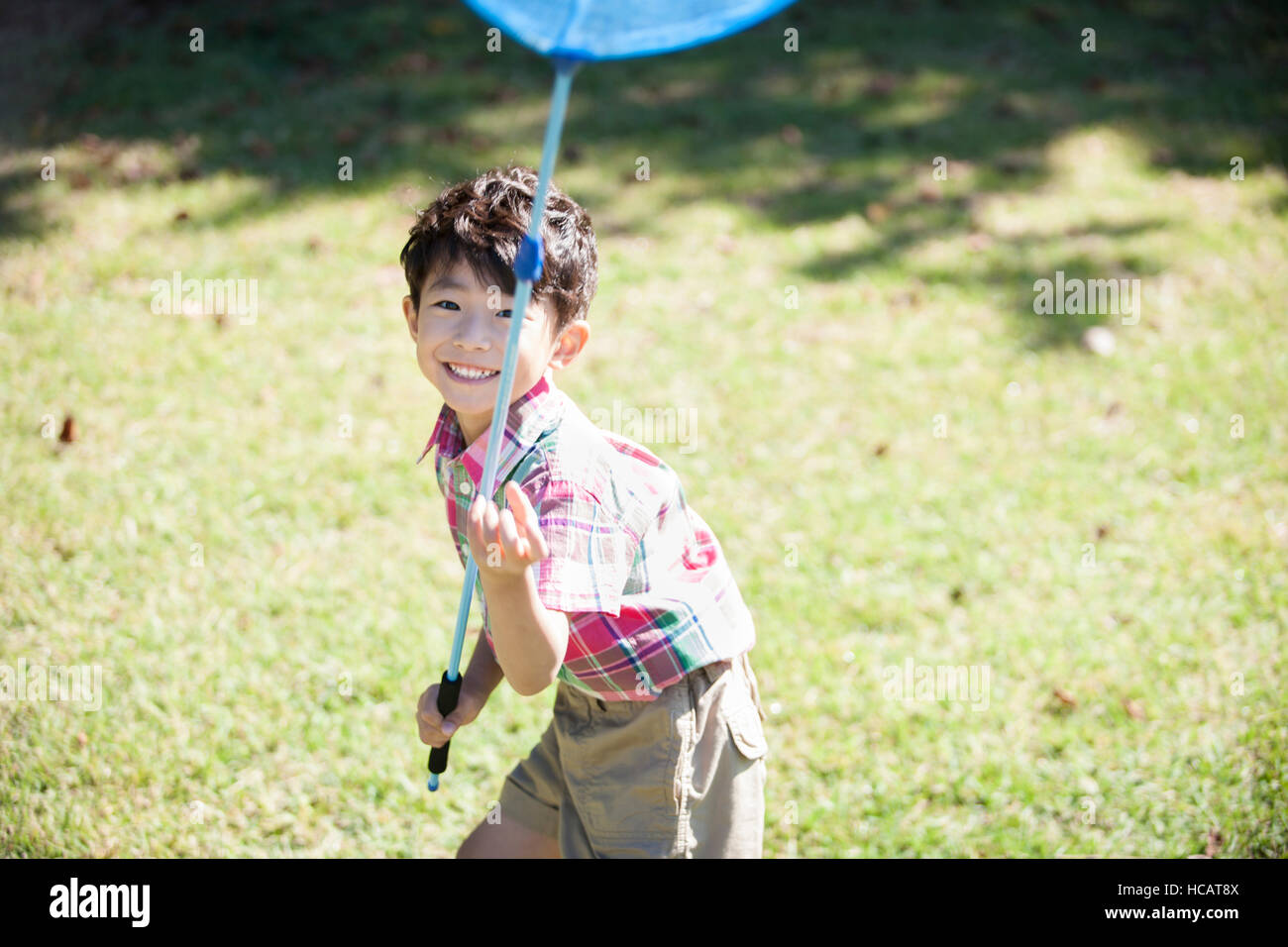 Smiling boy with a net outdoors Stock Photo - Alamy