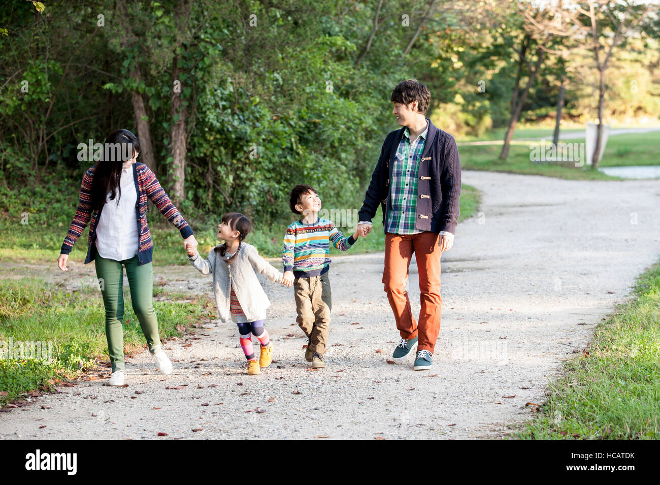 Harmonious family walking together outdoors Stock Photo - Alamy