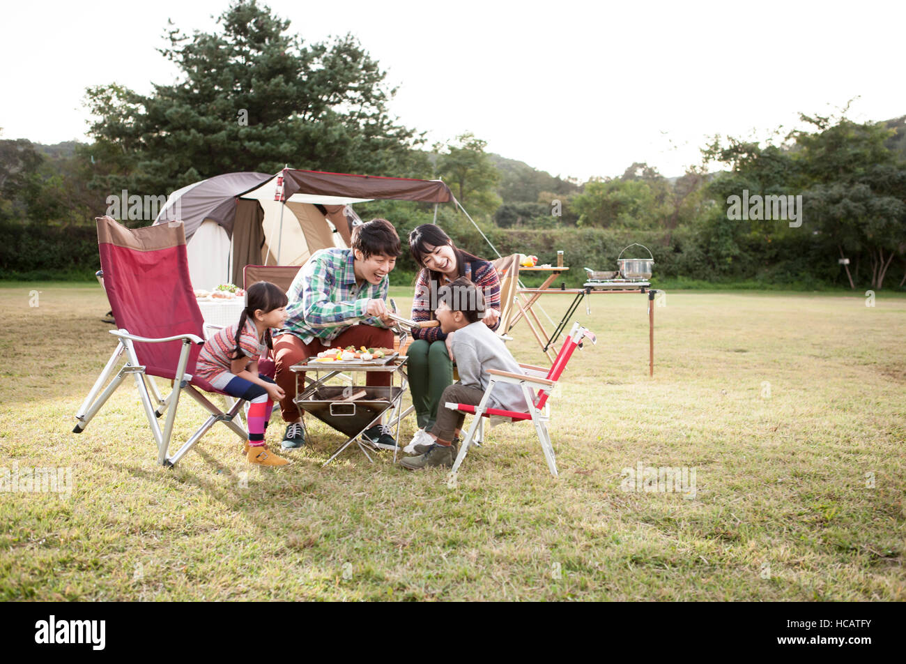 Harmonious family having camping Stock Photo - Alamy