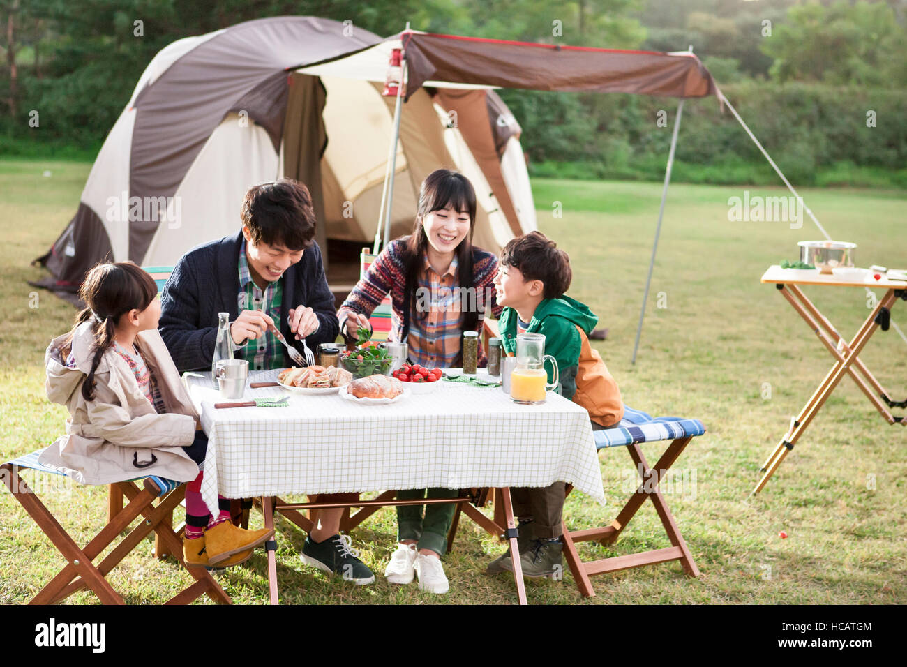 Harmonious family having camping Stock Photo - Alamy