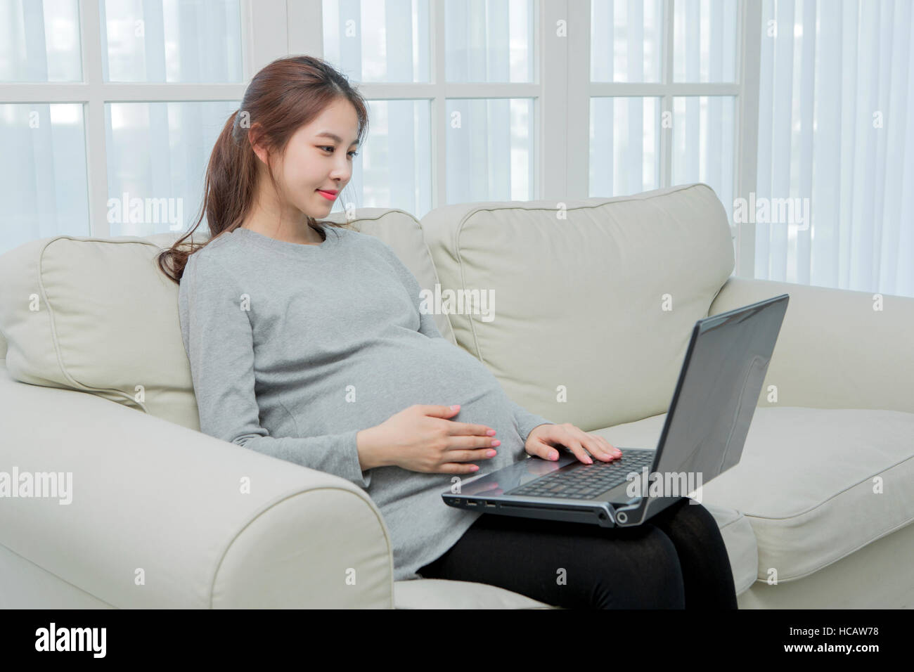 Pregnant asian woman using computer hi-res stock photography and images ...