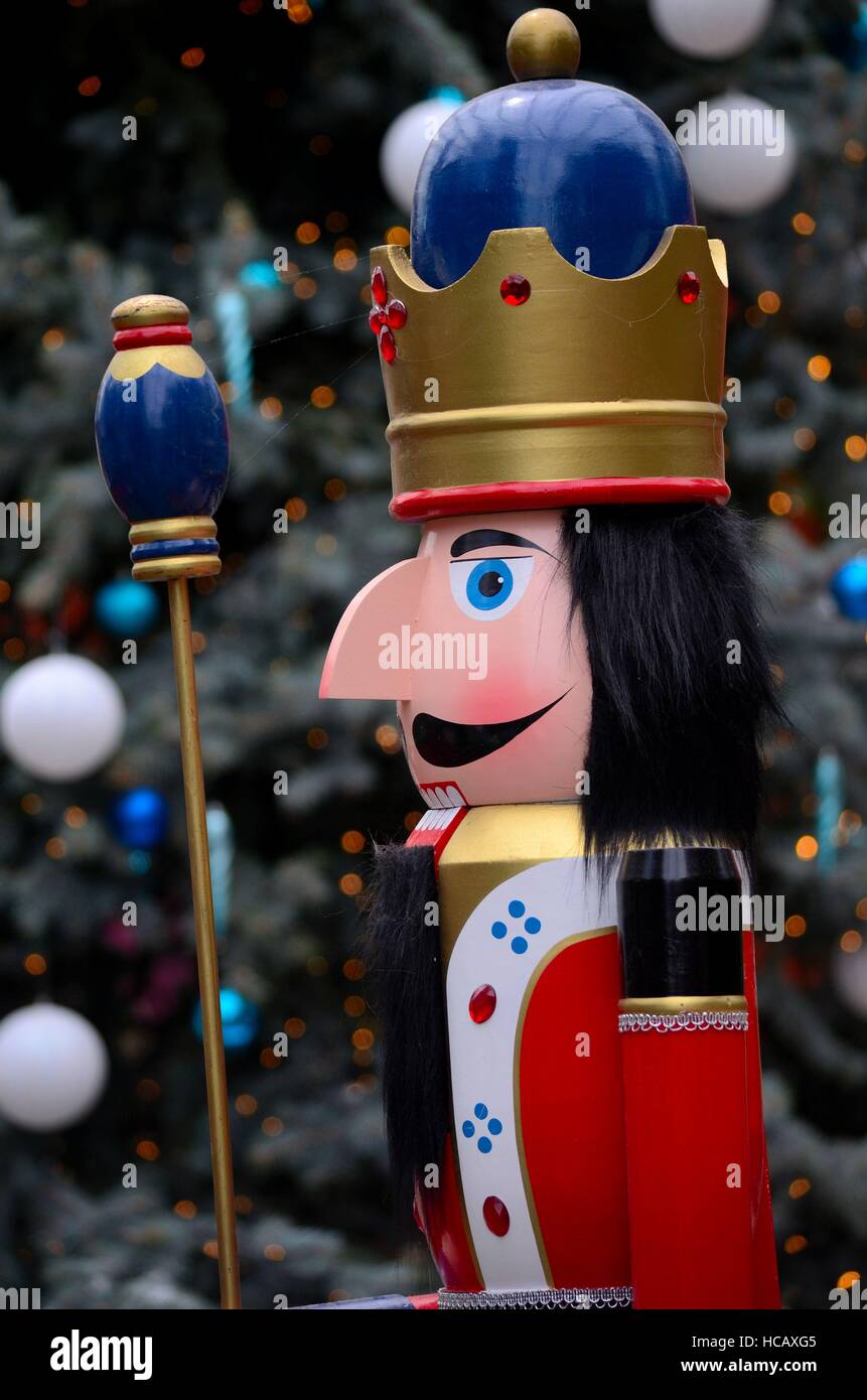Wooden Nutcracker prince statue holds blue and gold staff and gold and ...