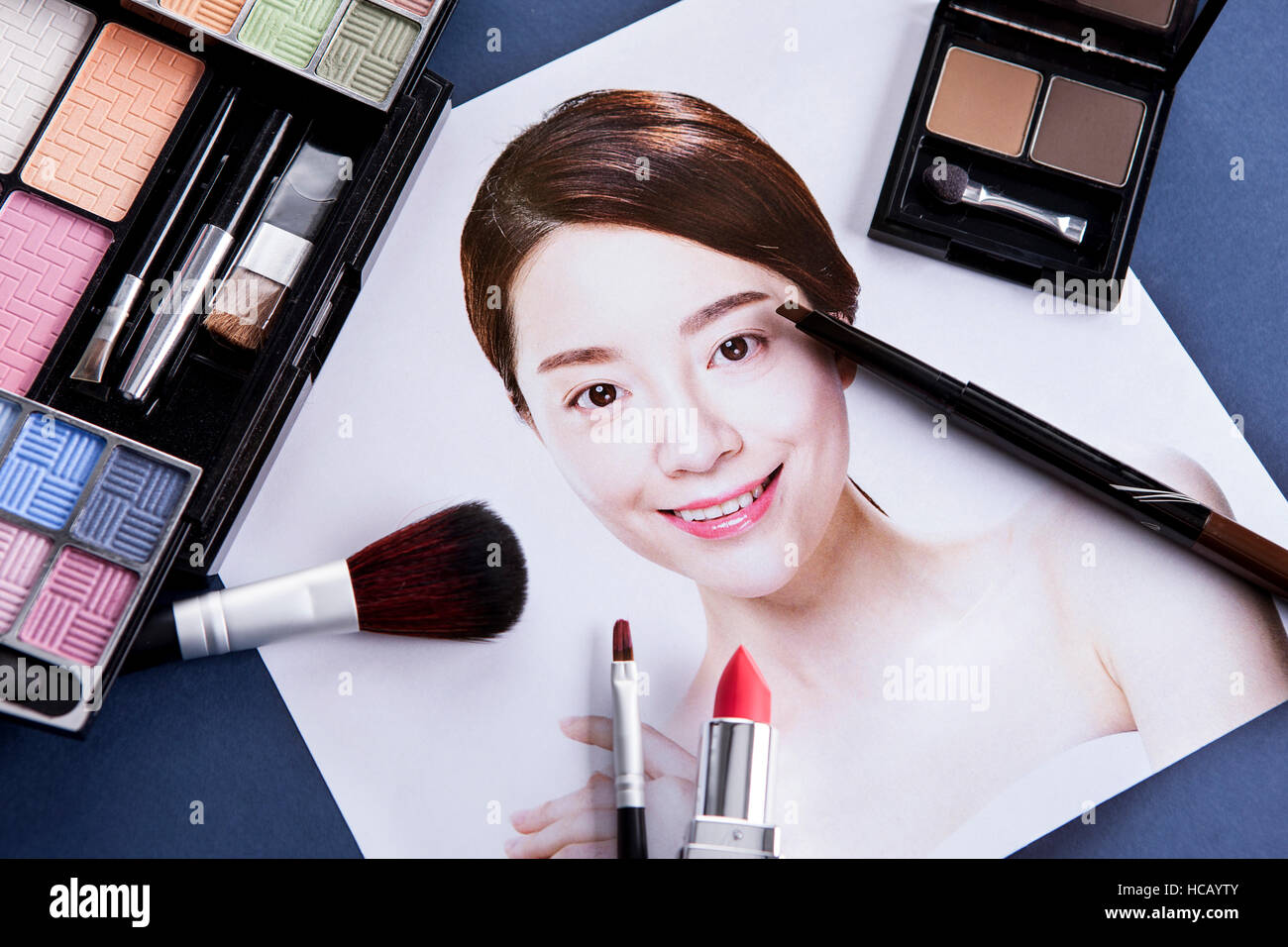 Photo of young smiling woman with various cosmetic products and beauty ...