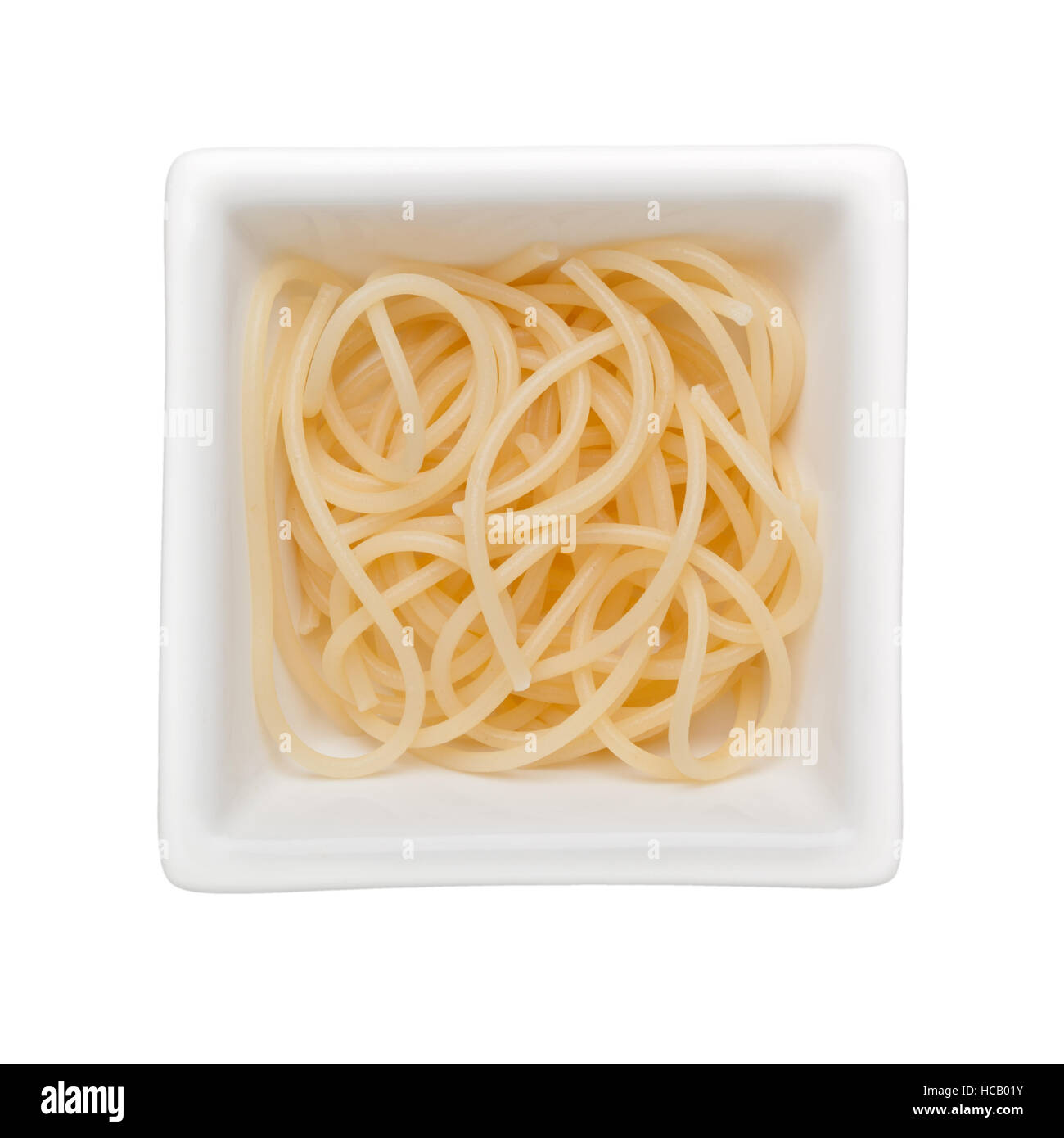 Cooked spaghetti in a square bowl isolated on white background Stock ...