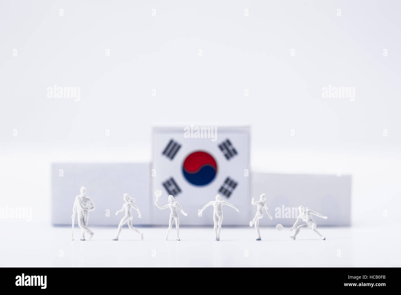Korean flag on victory stand and miniatures of various sports players ...