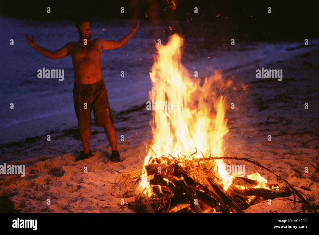 CAST AWAY, Tom Hanks and his fire, 2000. TM and Copyright (c) 20th ...