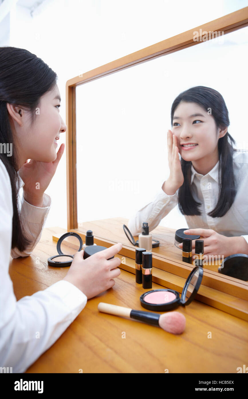 Side view portrait of adolescent girl putting on make up Stock Photo ...
