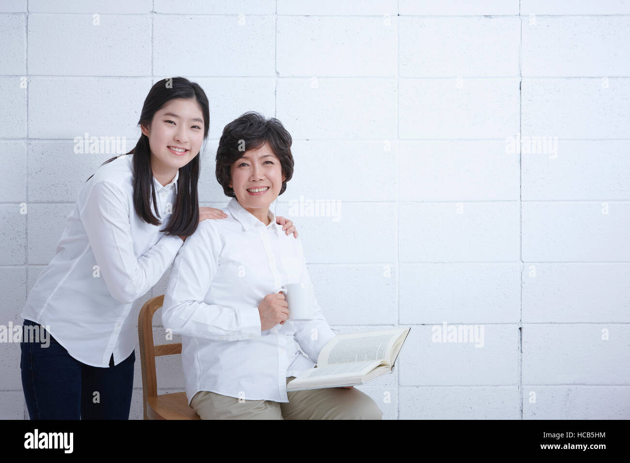 Smiling adolescent girl and smiling middle aged mother Stock Photo - Alamy