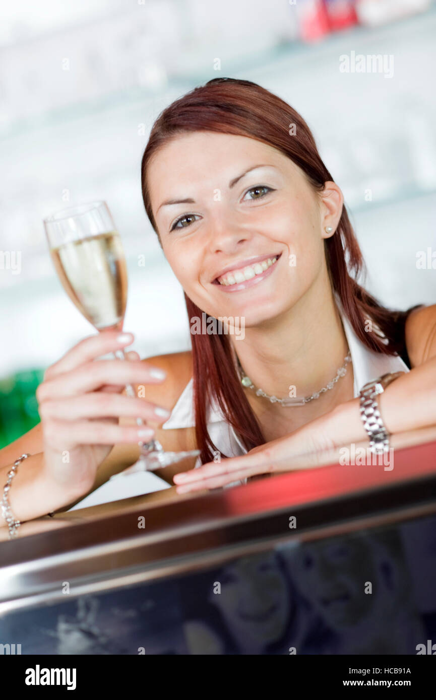 Young barmaid with champagne glass behind the bar Stock Photo - Alamy