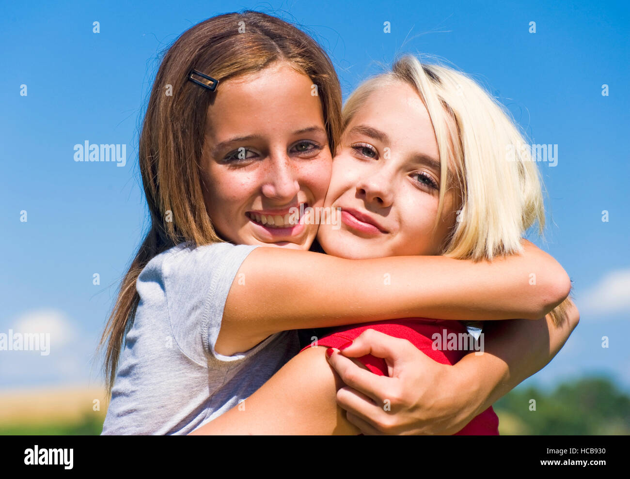 Teenage girl friends embracing each other Stock Photo - Alamy