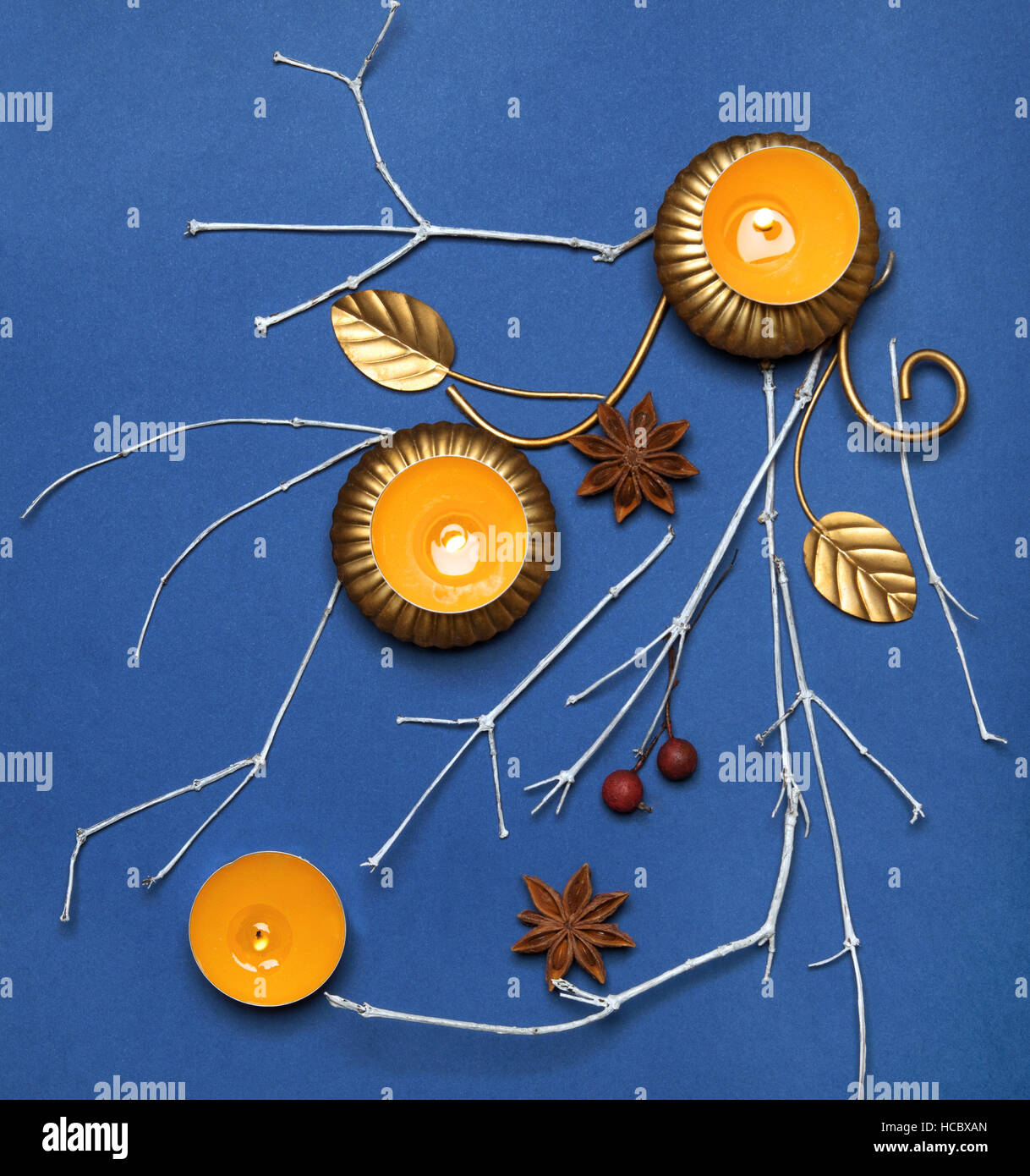 Composition made of three candles, branches and anise-tree seeds Stock ...