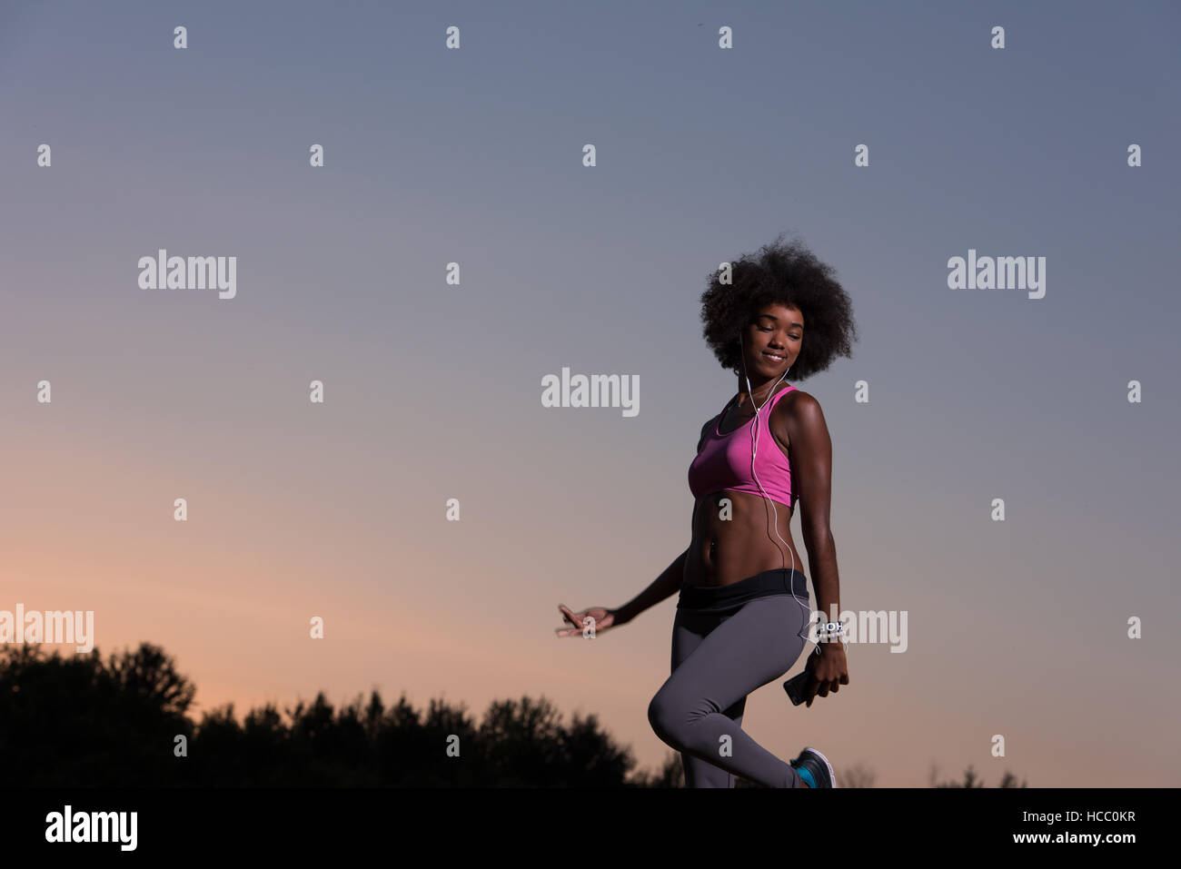 Young healthy black woman is doing stretching exercise relaxing and ...