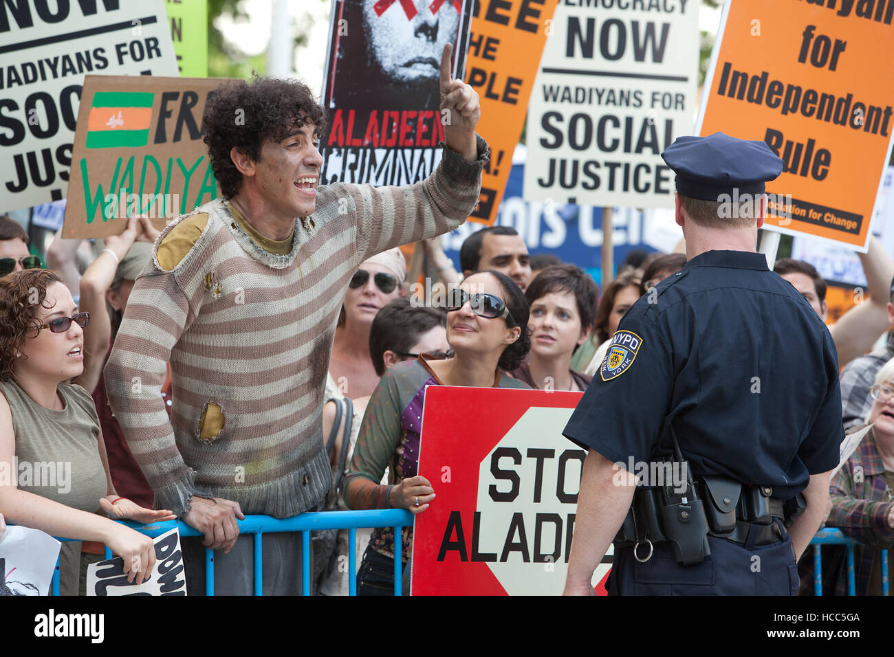 THE DICTATOR, Sacha Baron Cohen (top), Anna Faris (left of police ...
