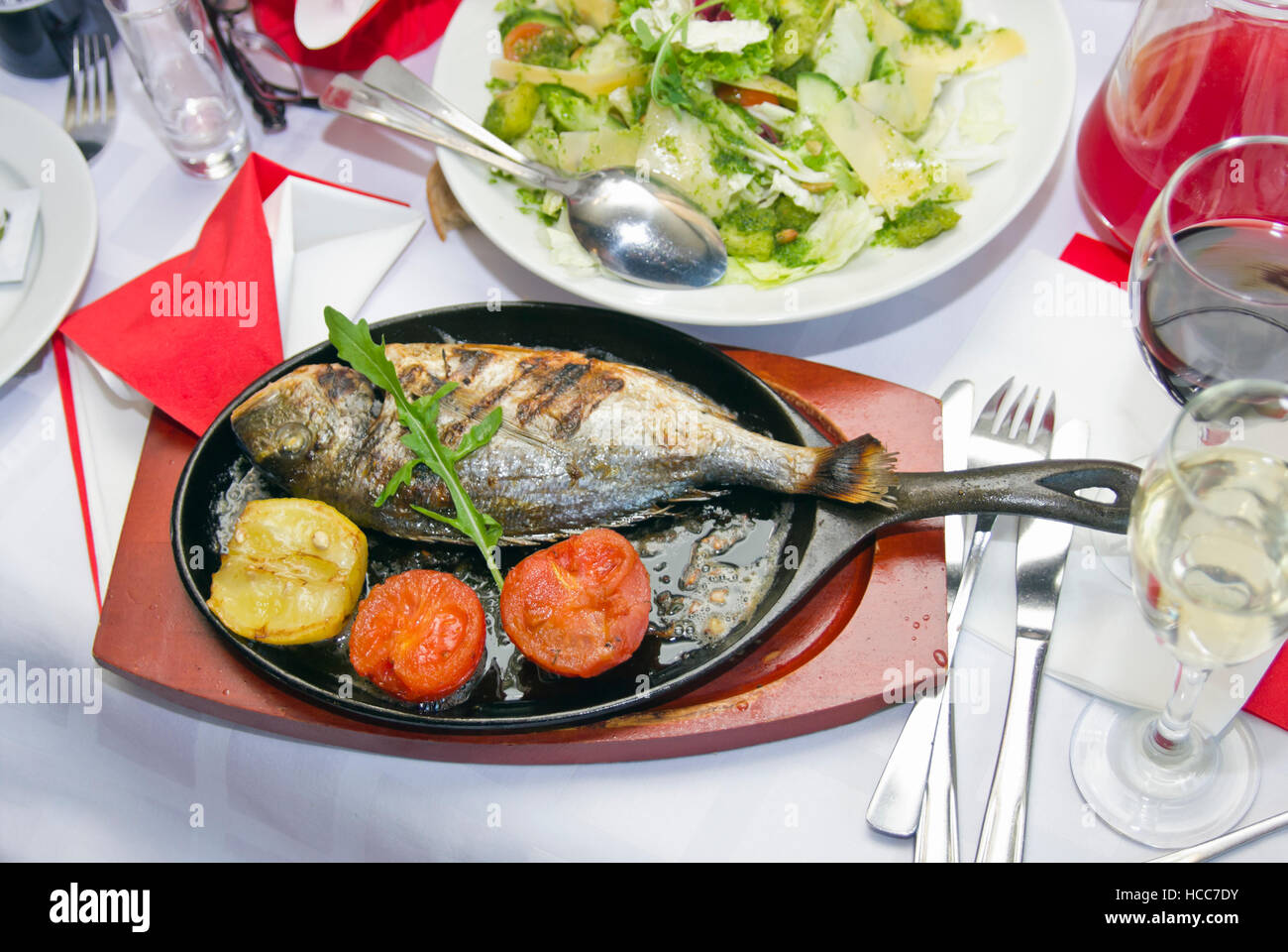 Restaurant Snapshot style photo. Delicious fish of a dolphin is baked ...