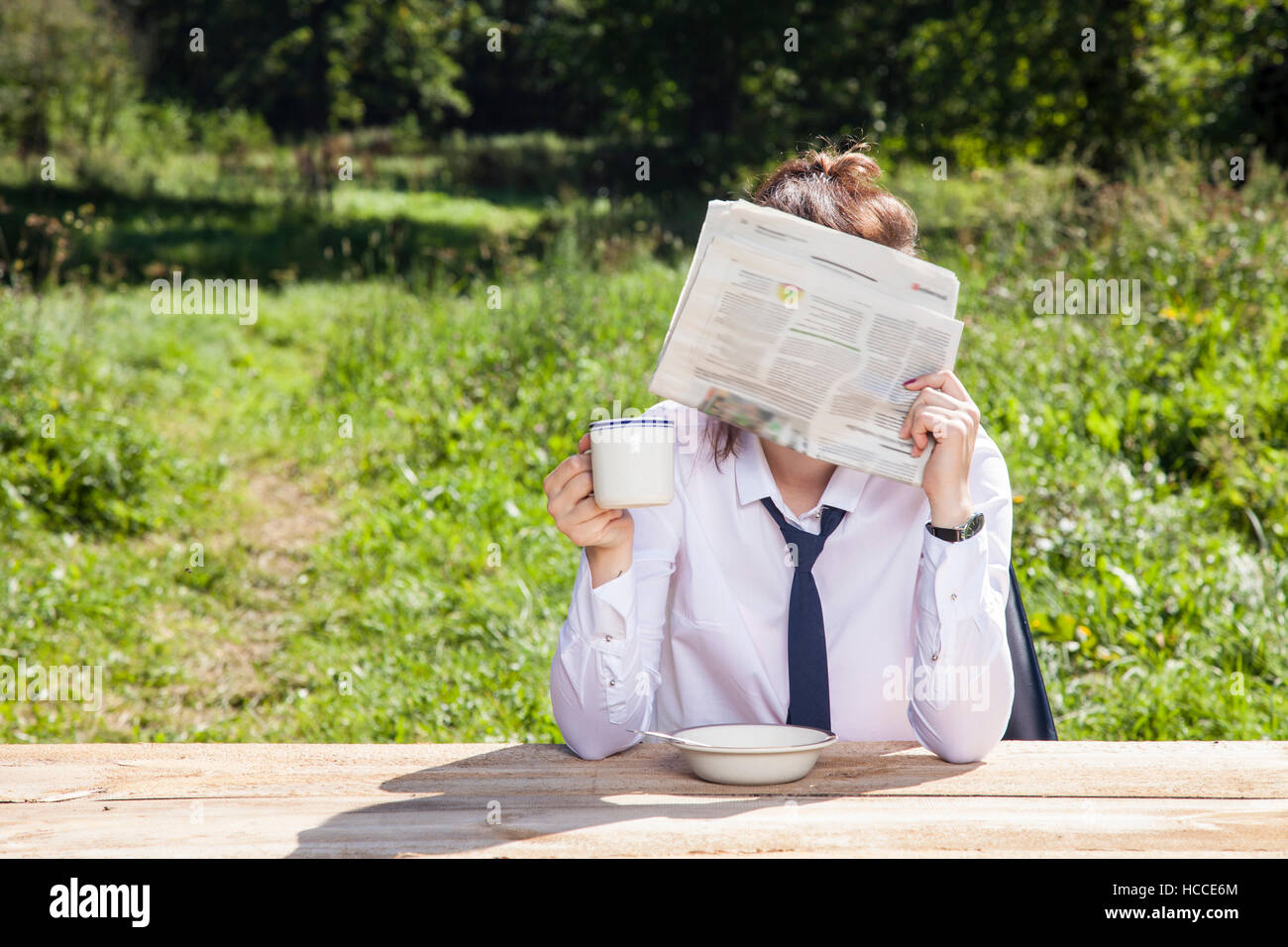 Hiding behind newspaper hi-res stock photography and images - Alamy