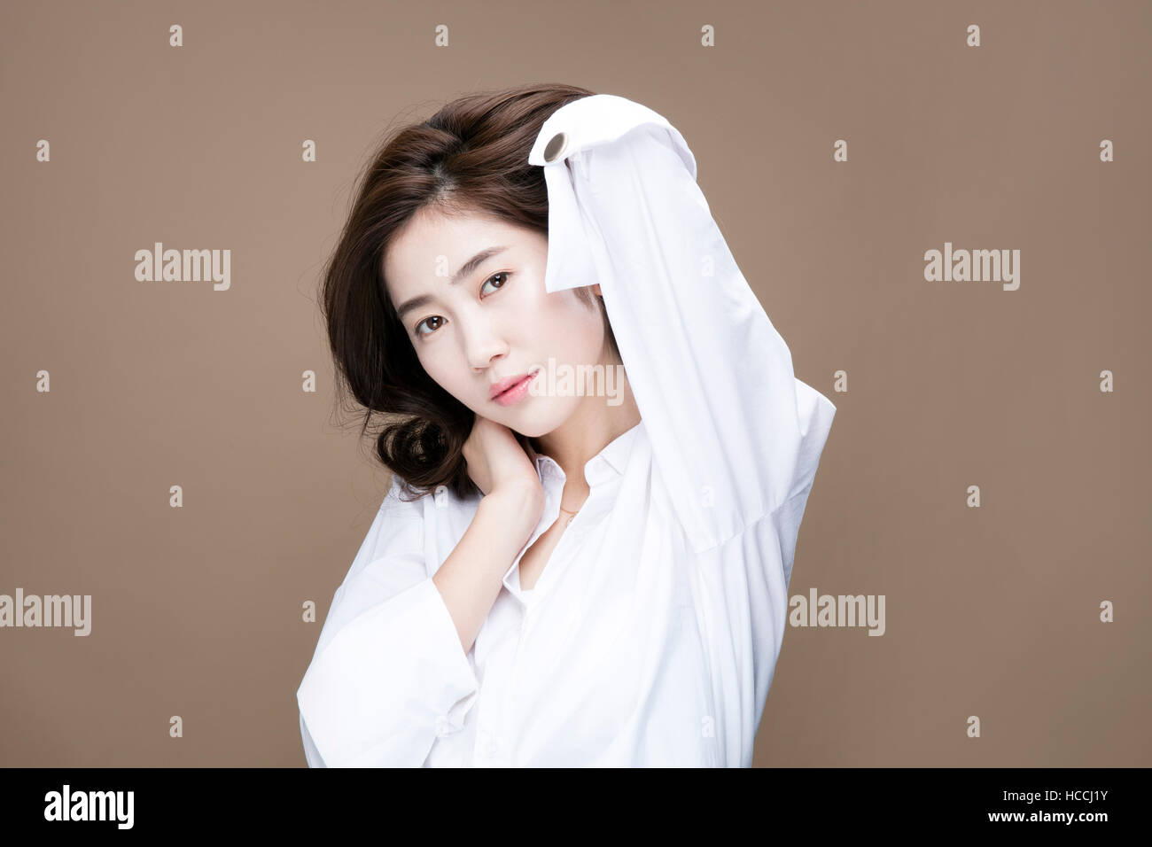 Portrait of young woman with long wavy hair and in white shirt Stock ...