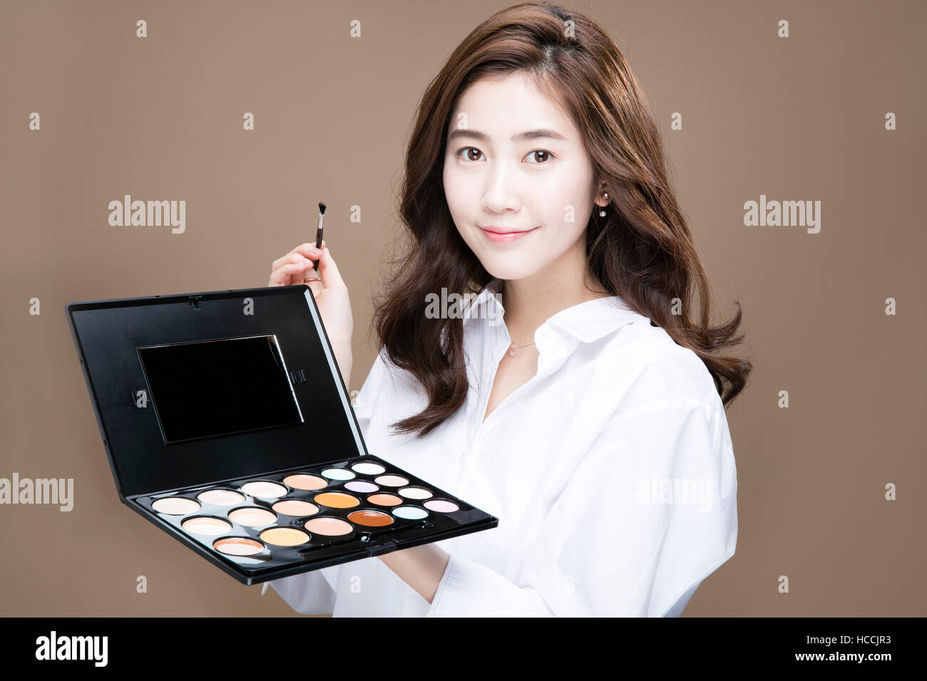 Portrait of young woman with cosmetic palette Stock Photo - Alamy