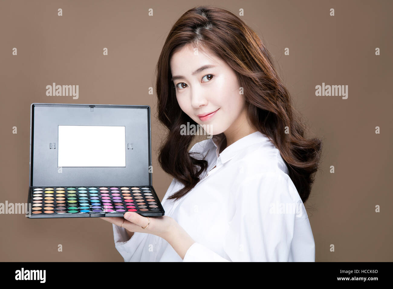 Portrait of young woman showing makeup palette Stock Photo - Alamy