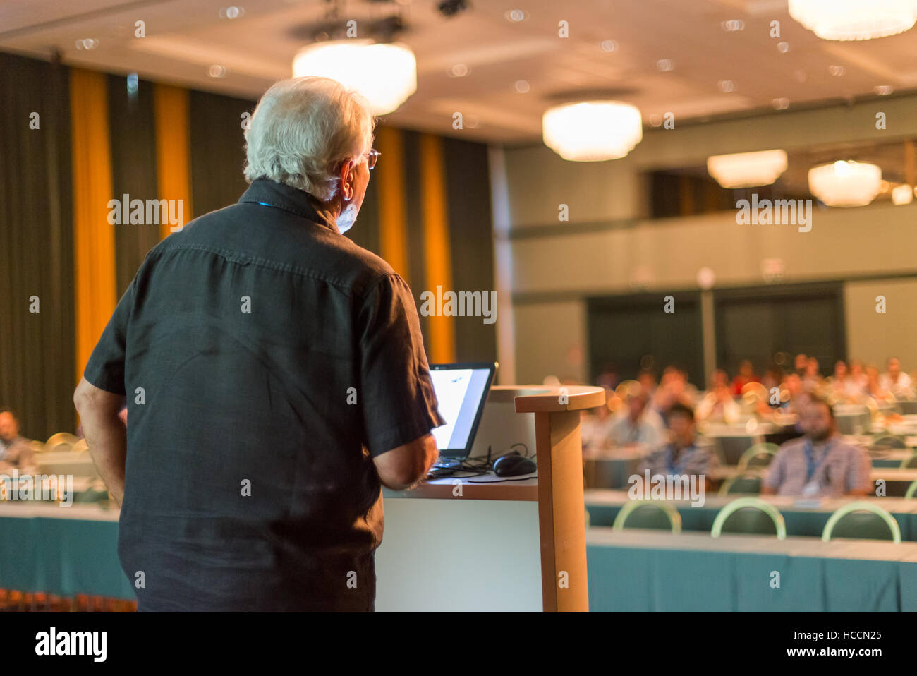 Senior public speaker giving talk at scientific conference Stock Photo ...