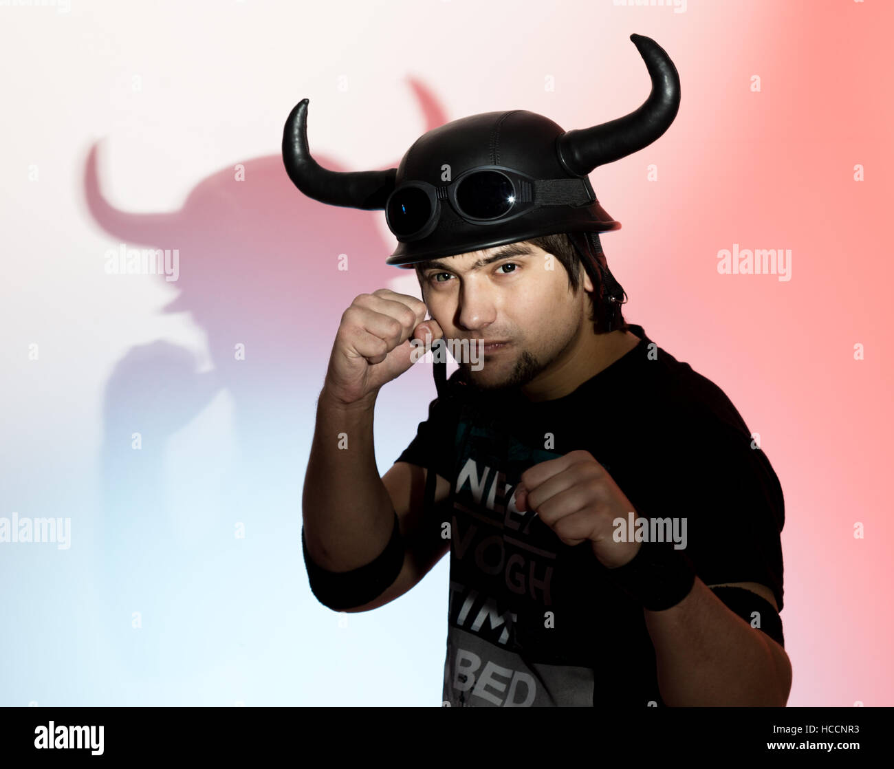 silhouette Rocker man in a horned helmet posing on red background Stock ...