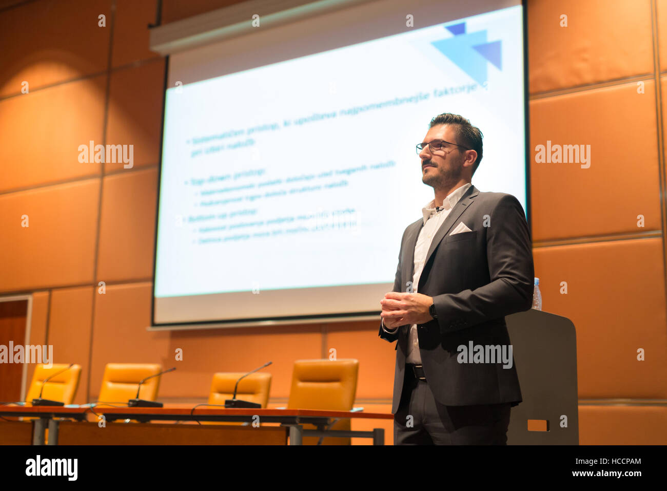 Speaker giving talk on podium at Business Conference Stock Photo - Alamy