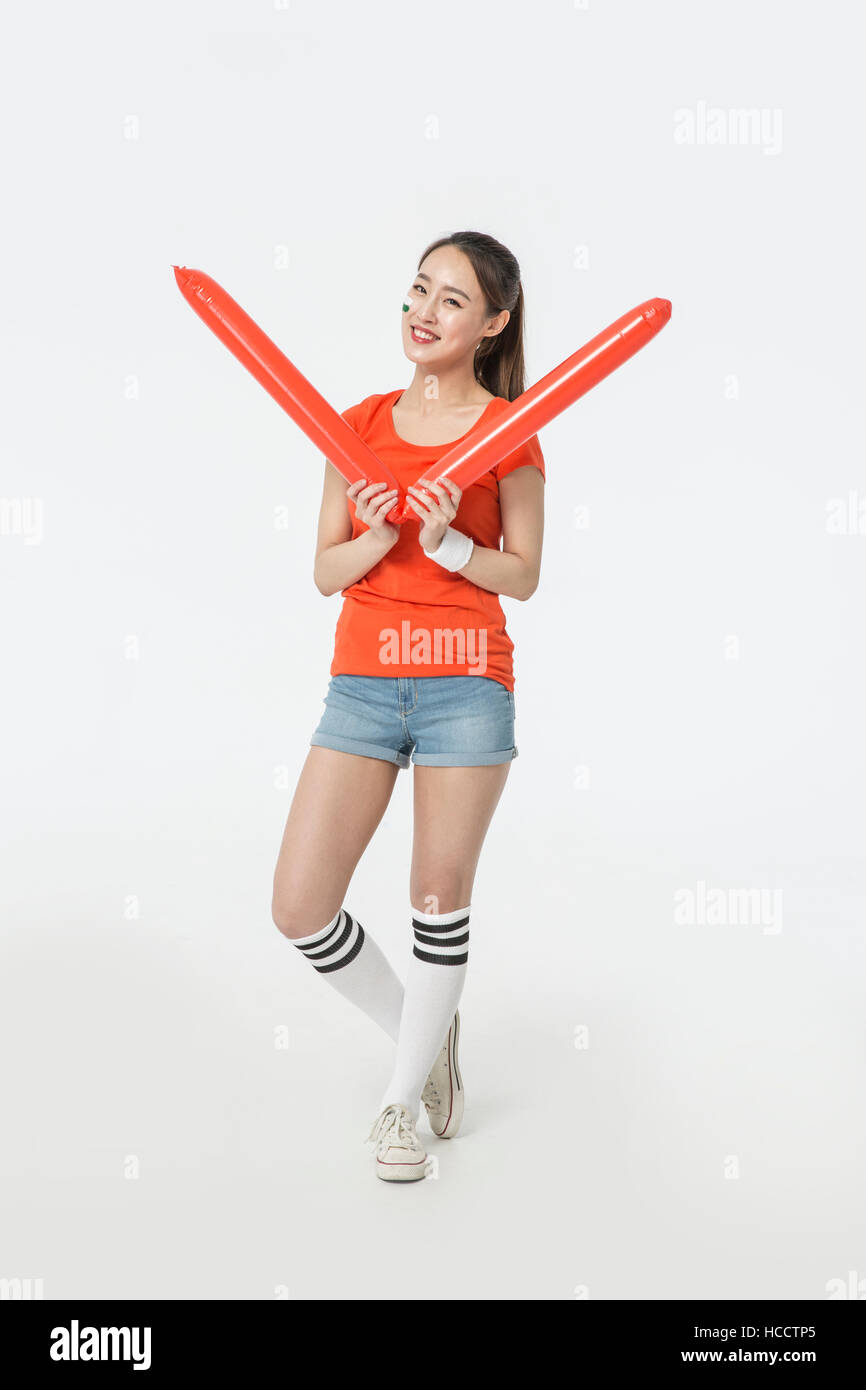 Young smiling woman with cheering tools Stock Photo - Alamy