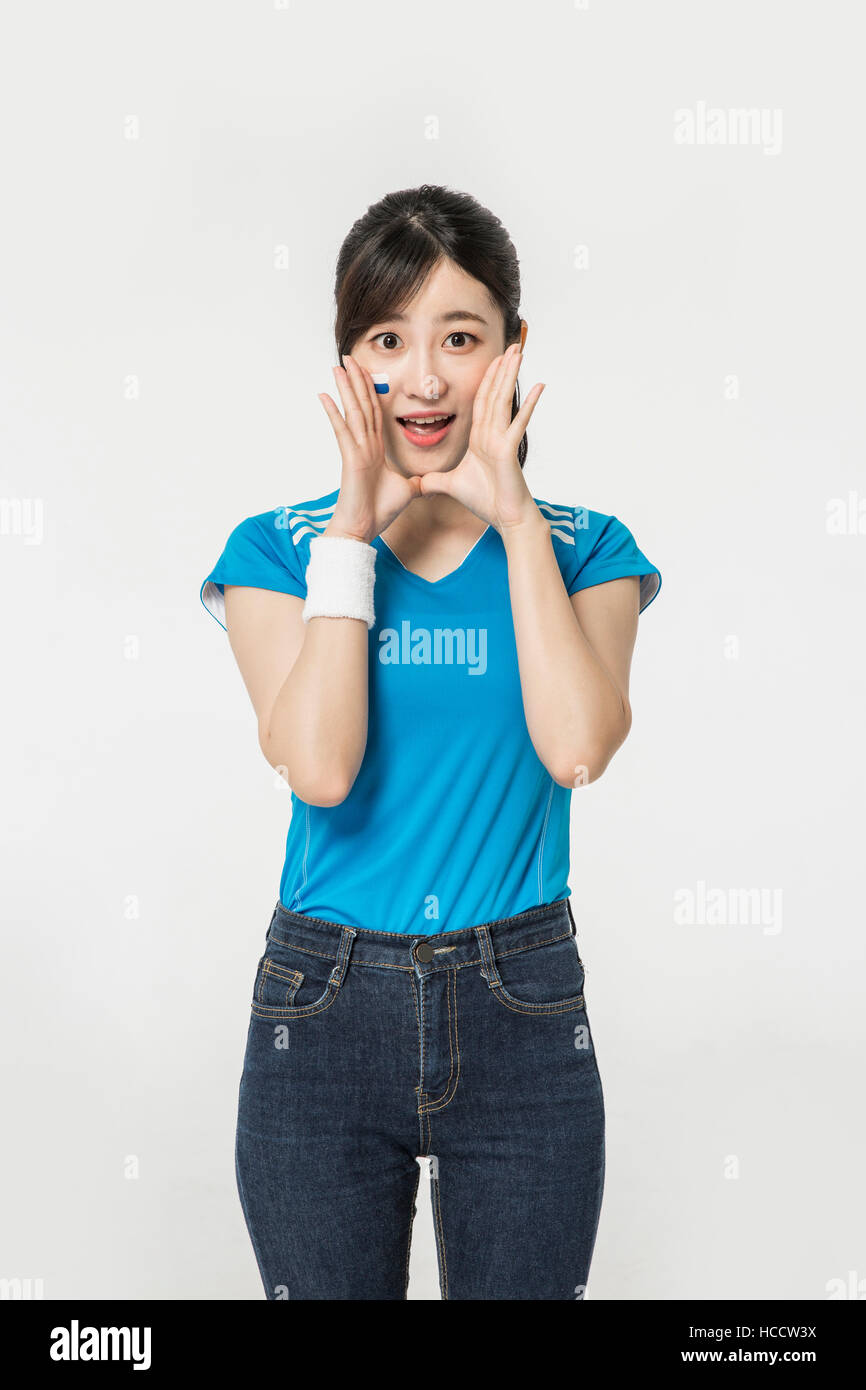 Young smiling woman cheering Stock Photo - Alamy