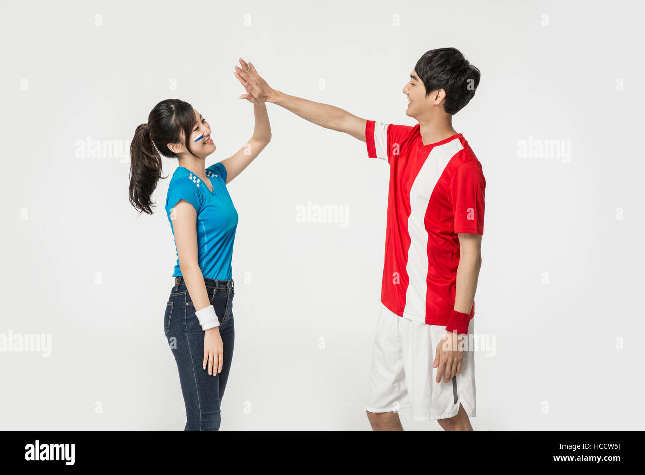 Side view of young smiling man and woman cheering Stock Photo - Alamy