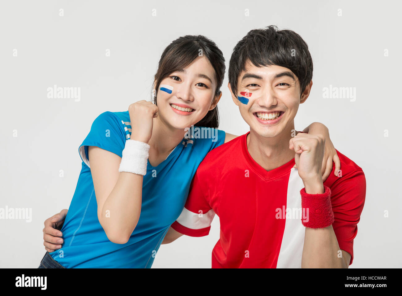Portrait of young smiling man and woman cheering Stock Photo - Alamy